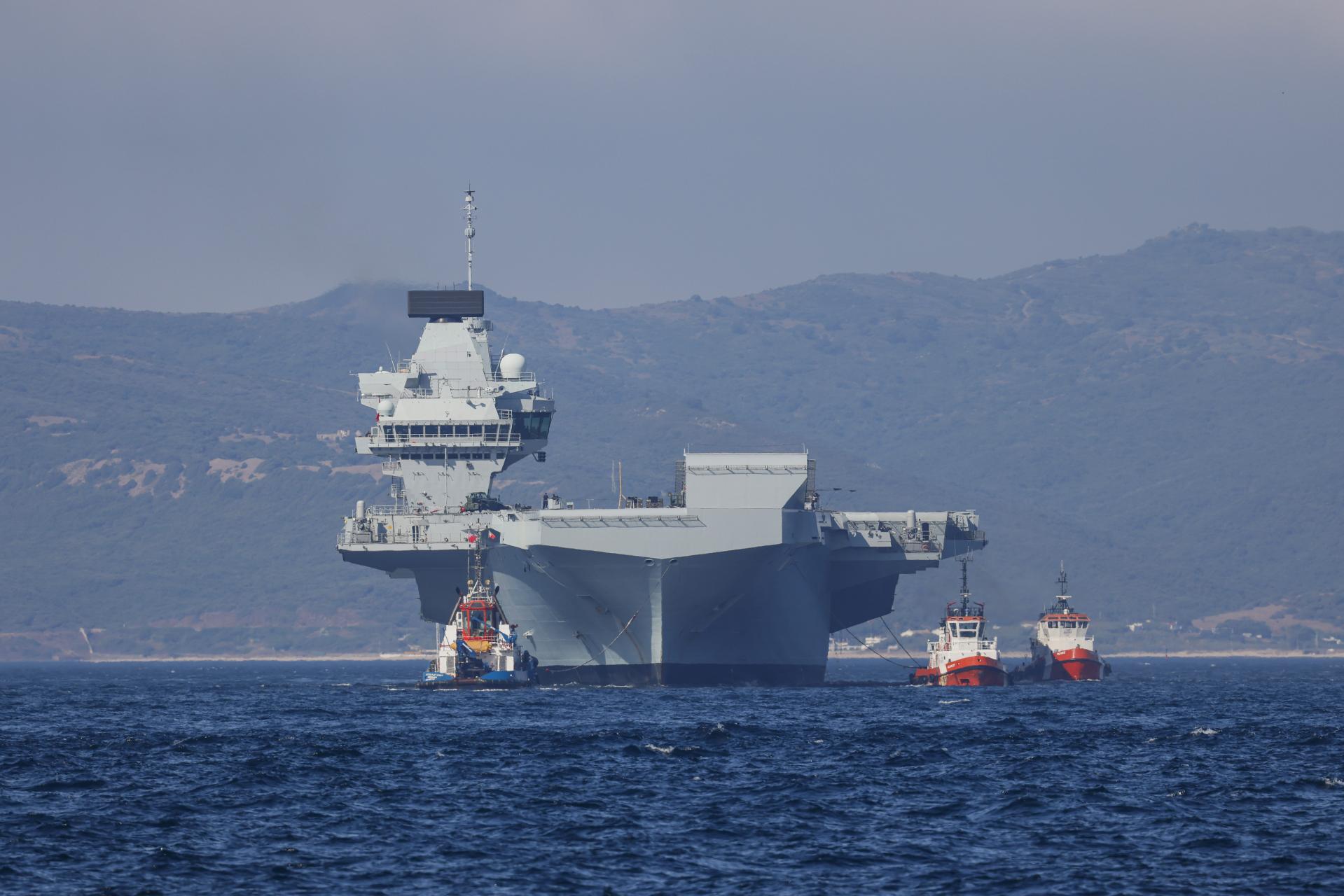 Royal Navy flagship docks in Gibraltar with traditional gun salute